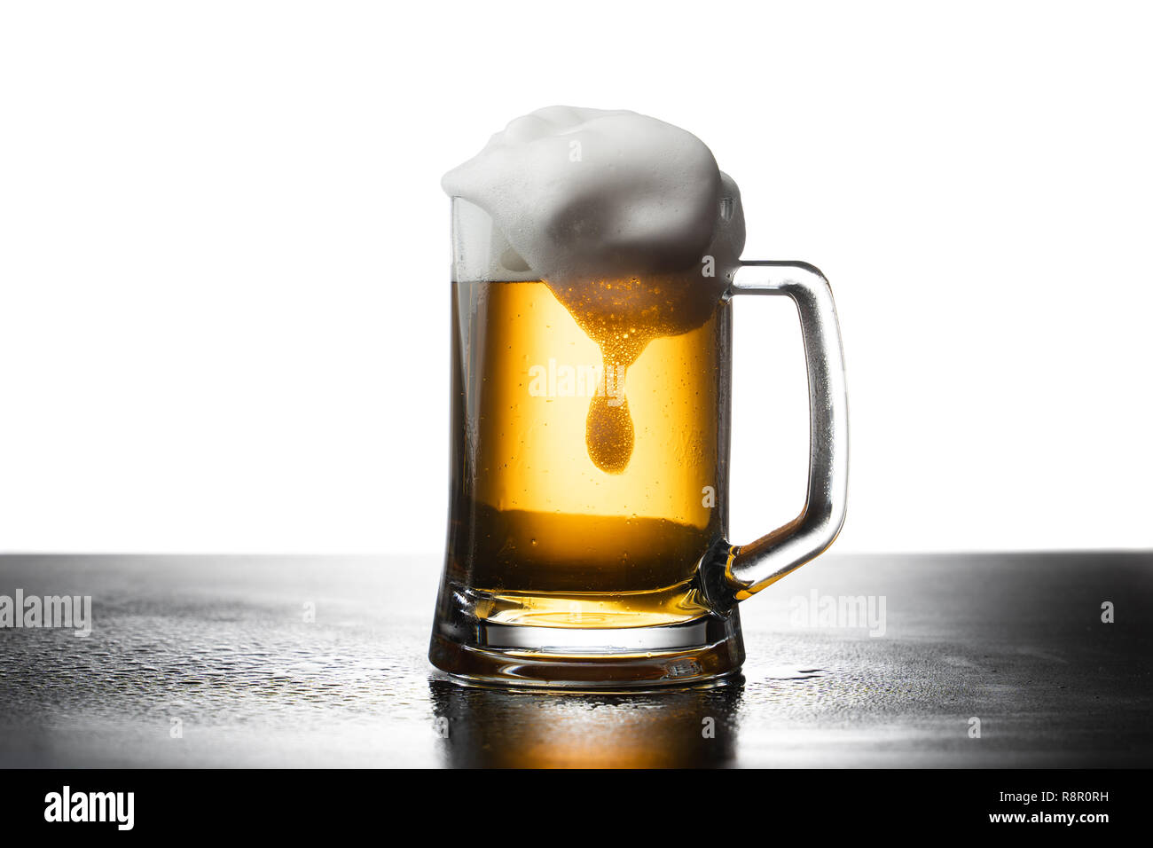 Frosty mug of light beer on black table Stock Photo - Alamy
