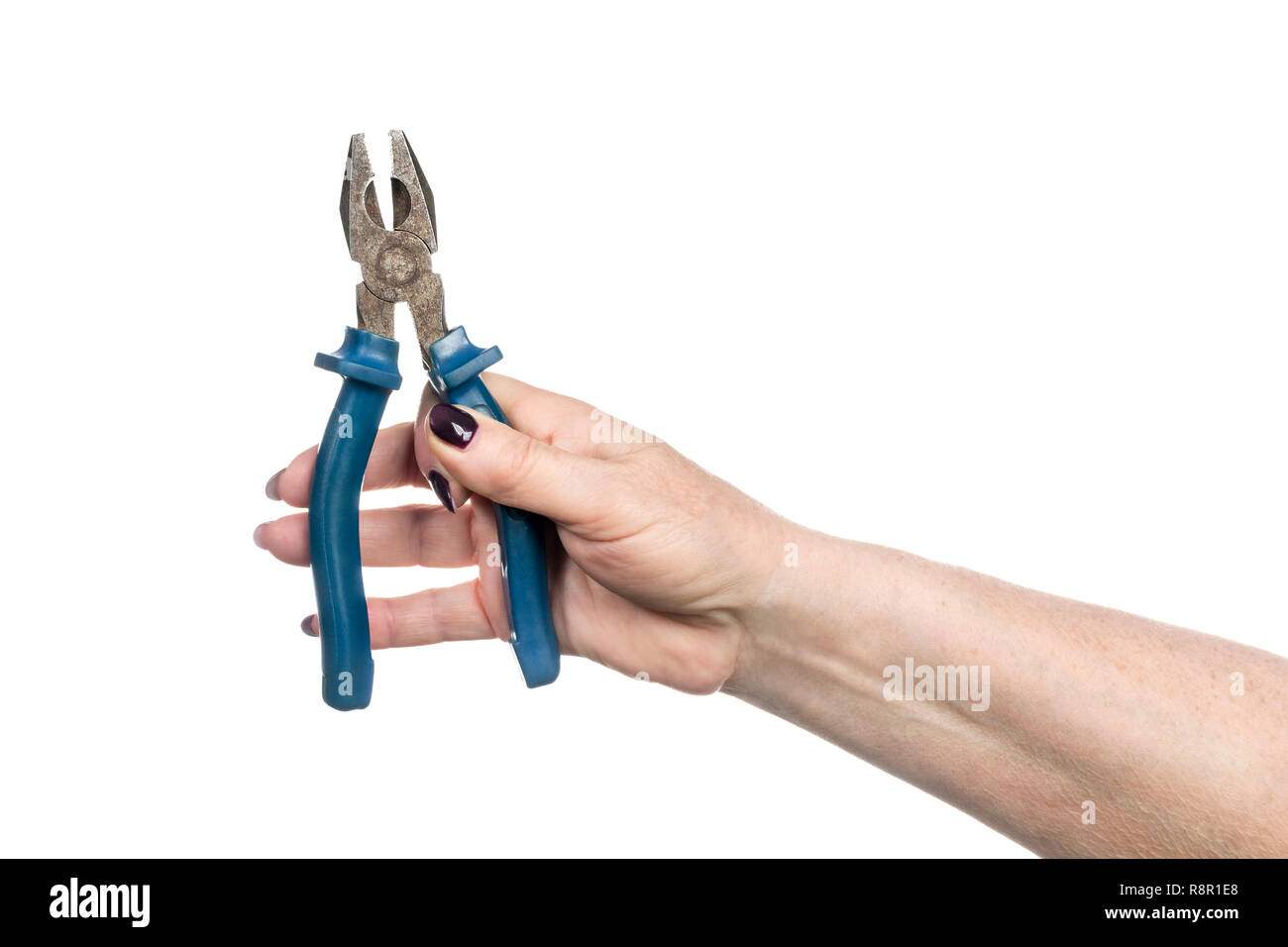 old pliers in female hand with manicure isolated on white background ...