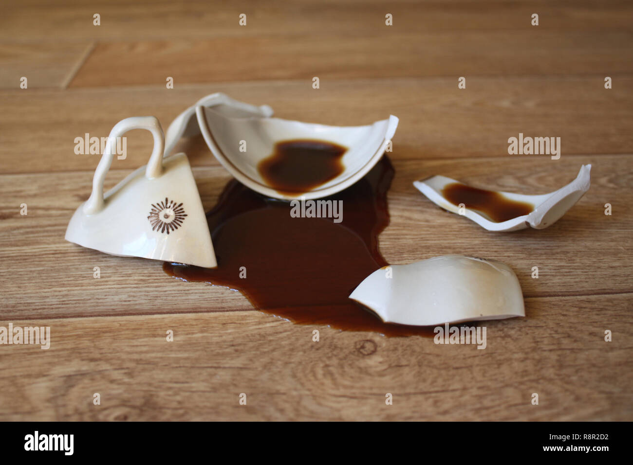Coffee, flowed out from the broken cup Stock Photo - Alamy