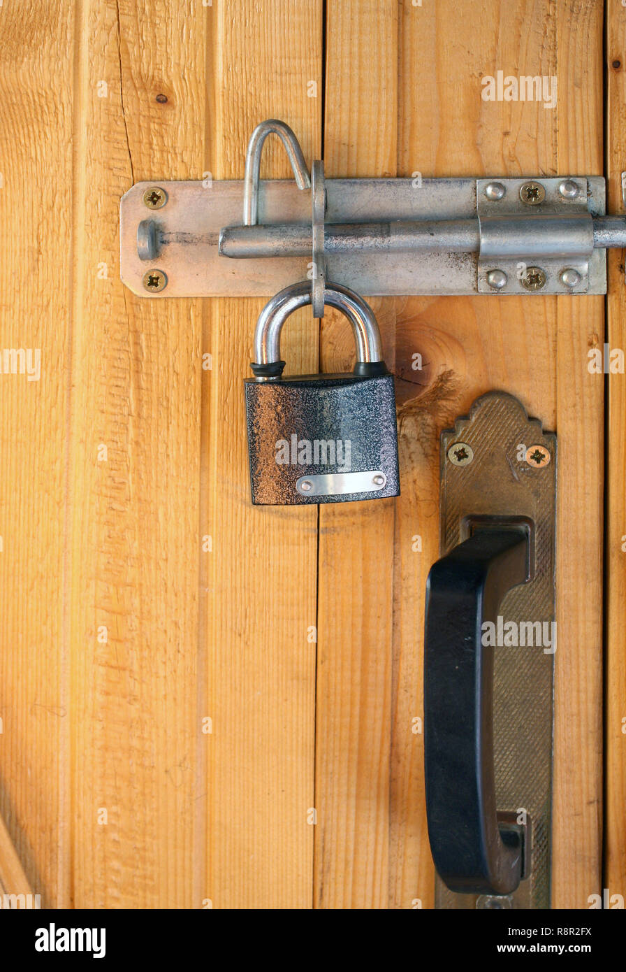 The closed lock on a wooden door Stock Photo - Alamy