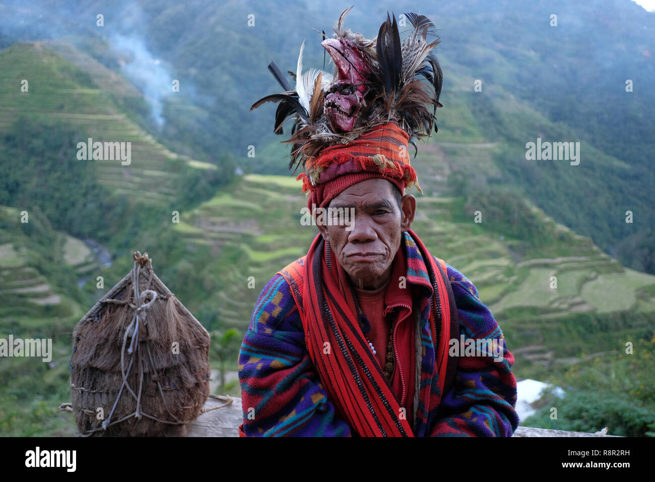 An elderly Ifugao man wearing traditional garment and headdress adorned ...