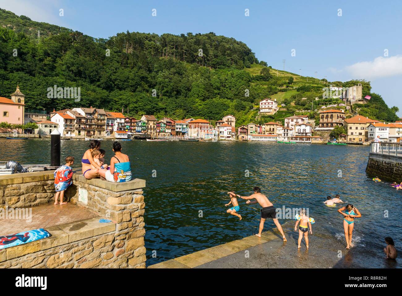 Spain, Guipuzkoa, Bask Country, Pasaia, Young people dive and bathe in ...
