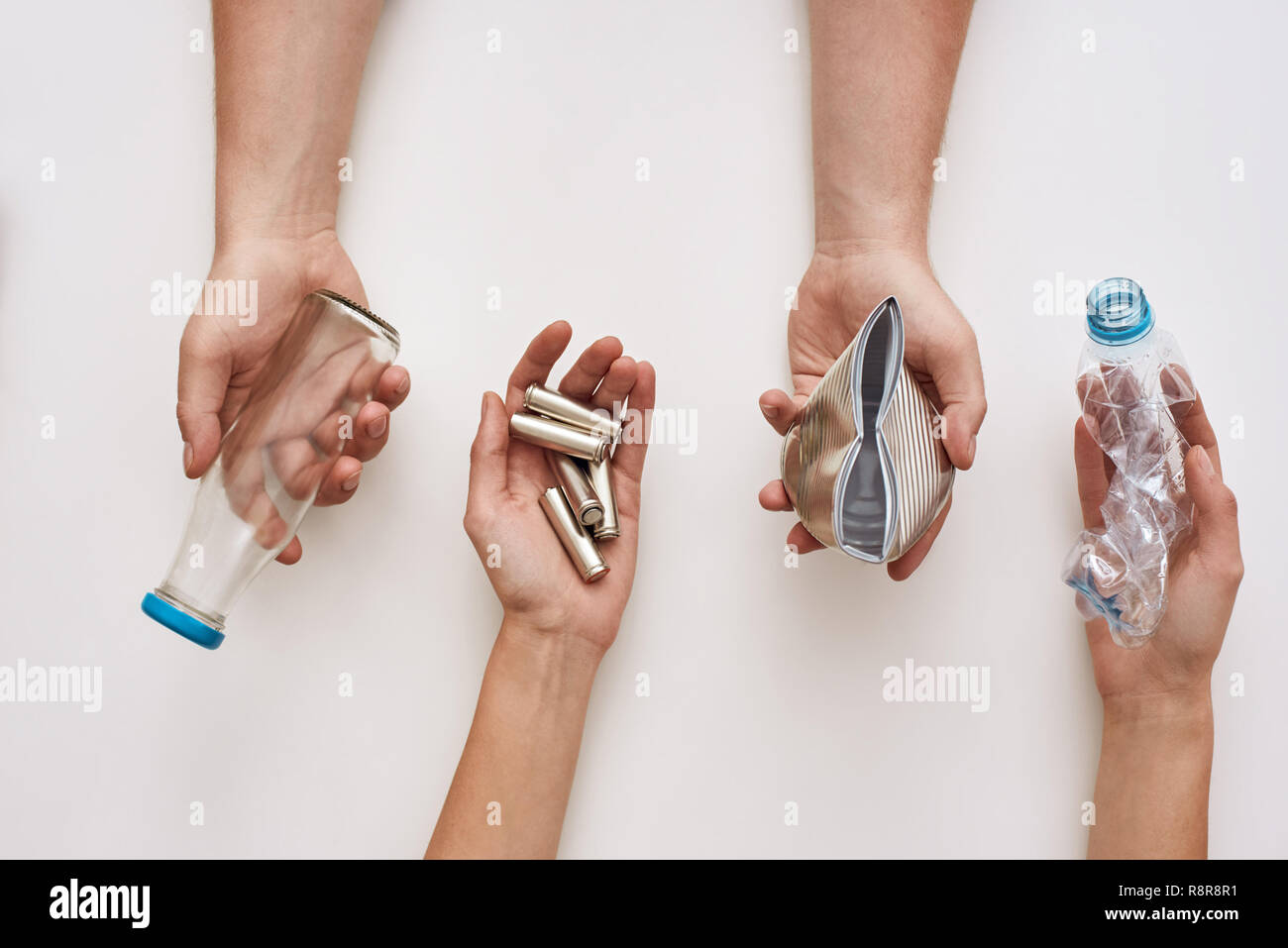 Sparate your trash. Four types of garbage in human hands Stock Photo ...