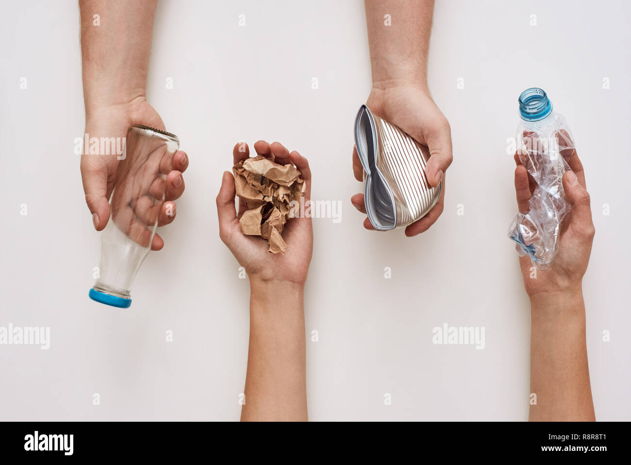 Sparate your trash. Four types of garbage in human hands Stock Photo ...