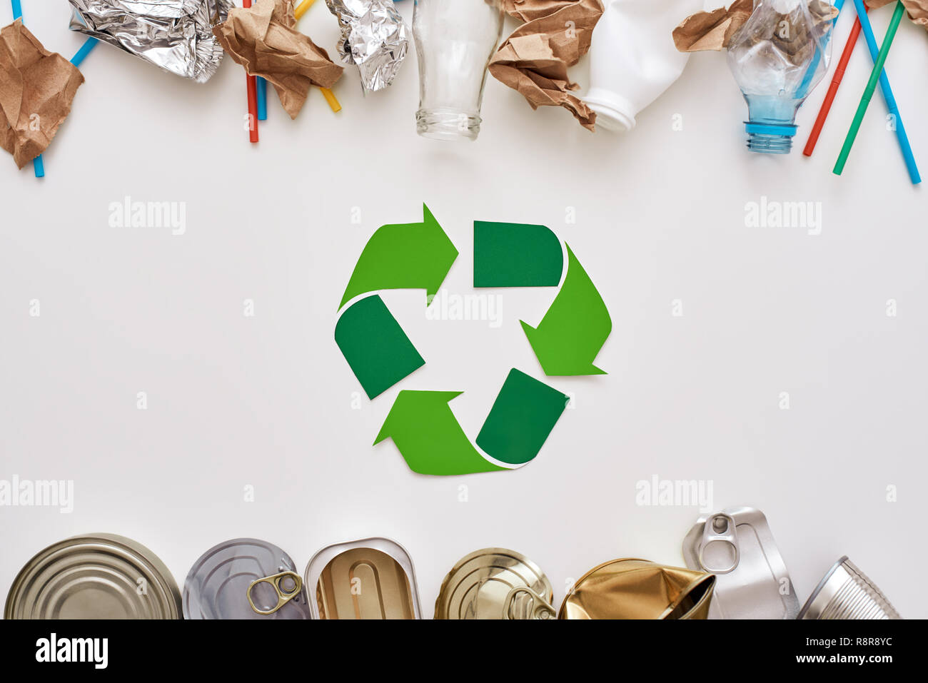 Save the world. Canned garbage, sorted separately near recycle symbol ...