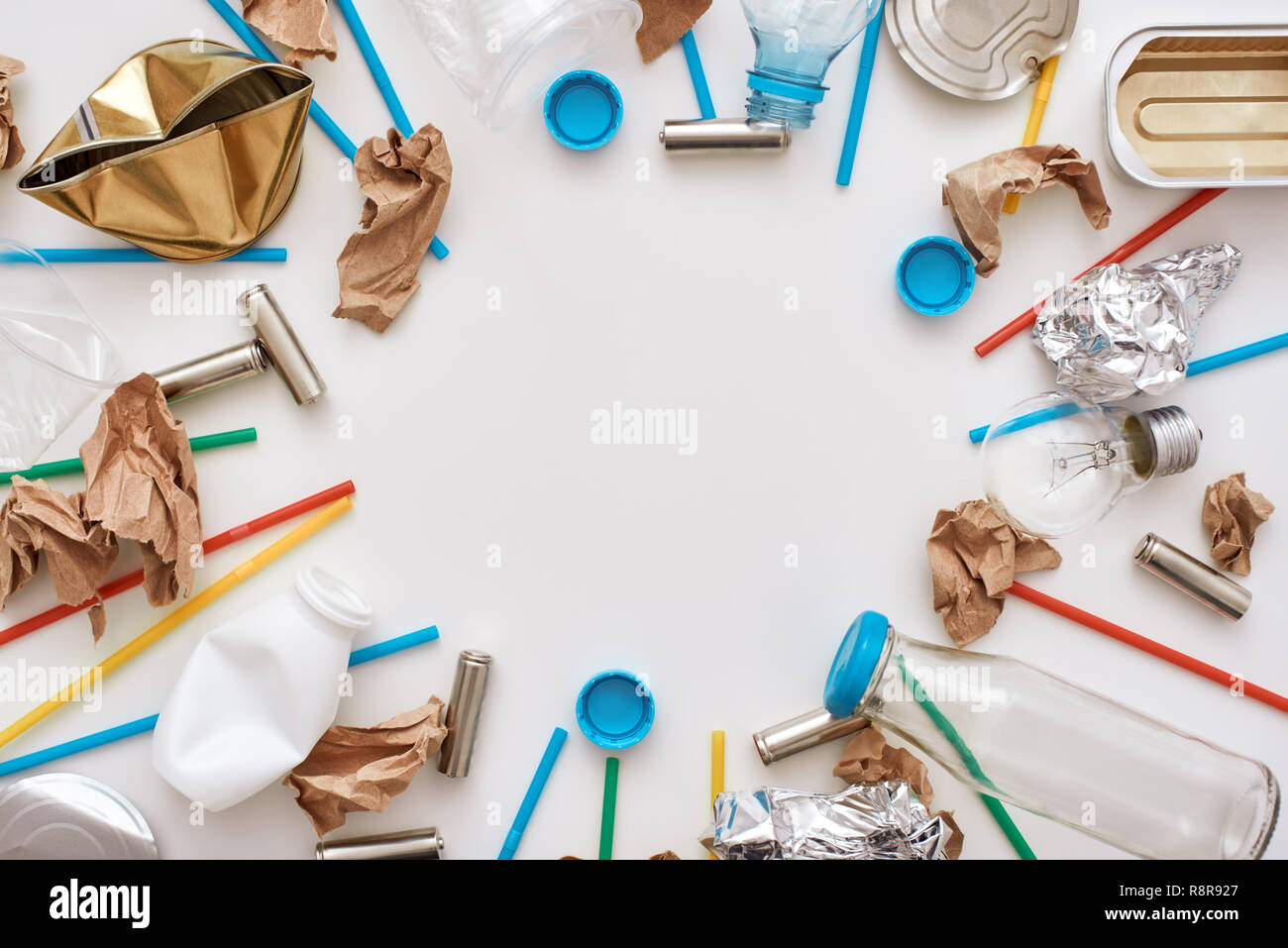 Garbage circle. Different types of unsorted garbage around the floor ...