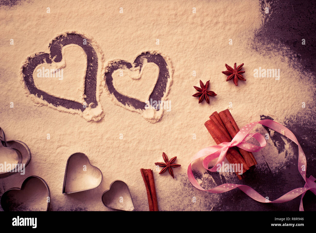 Background for Valentine's Day baking with hearts and flour Stock Photo ...