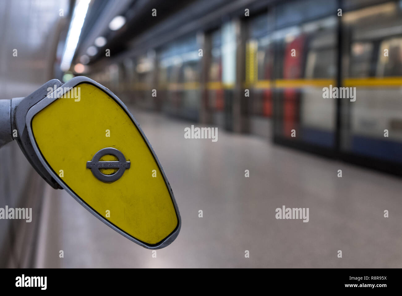 In foreground, end of handrail at Southwark underground station, London ...