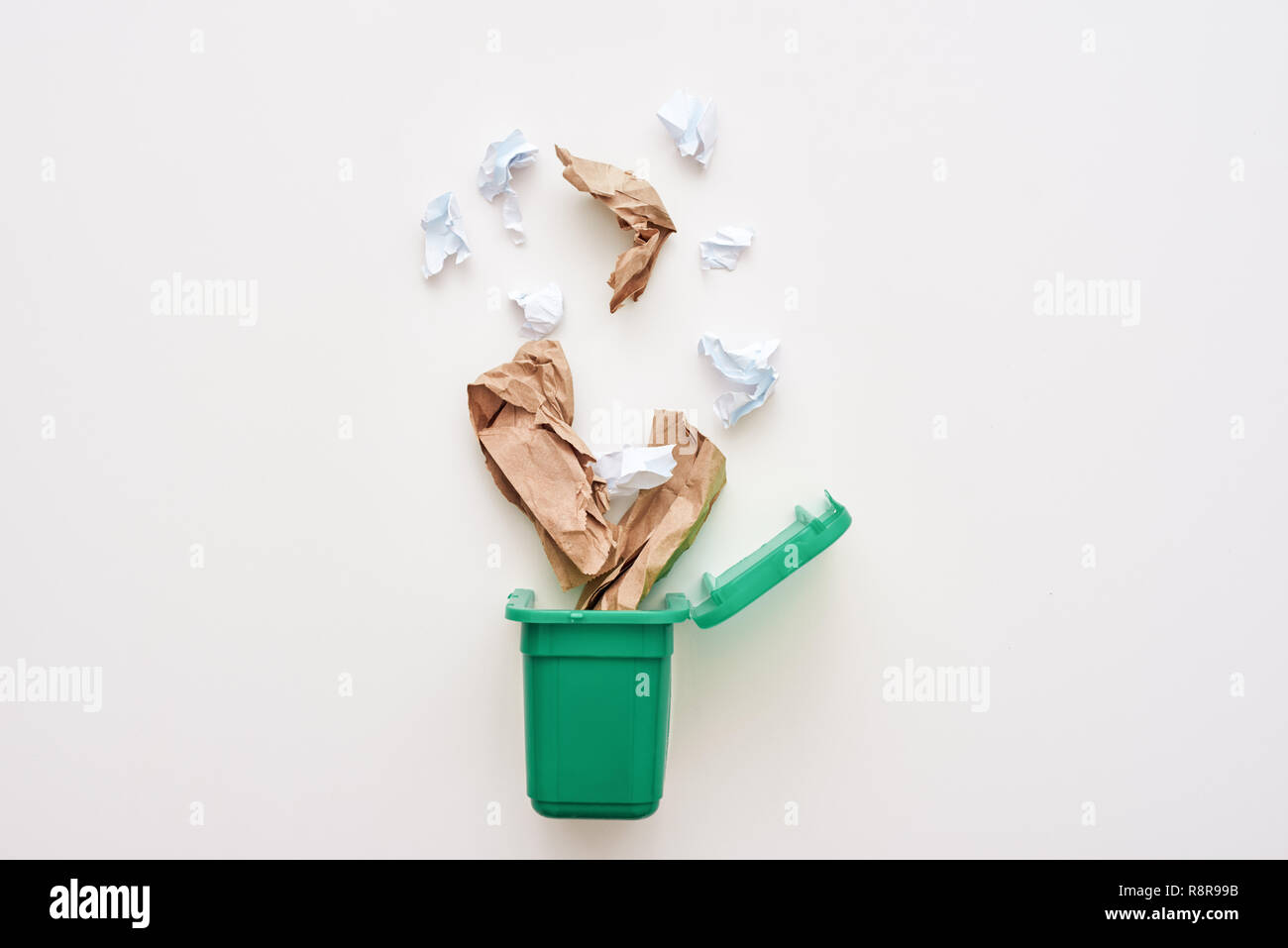 Paper trash. Crumple paper falling to the recycling bin Stock Photo - Alamy