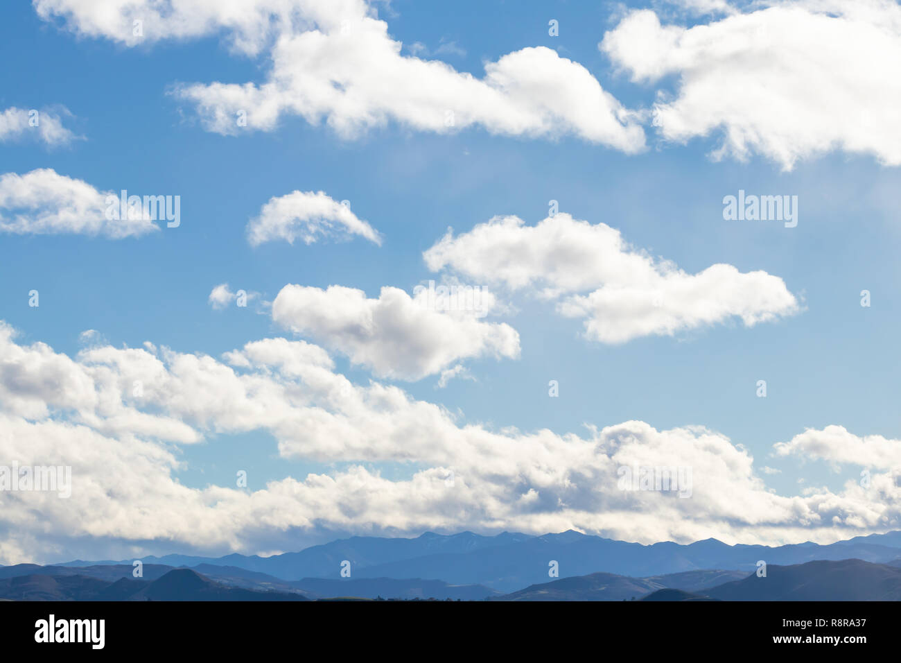 Mountain range in clear weather in contrasting rain clouds before the ...