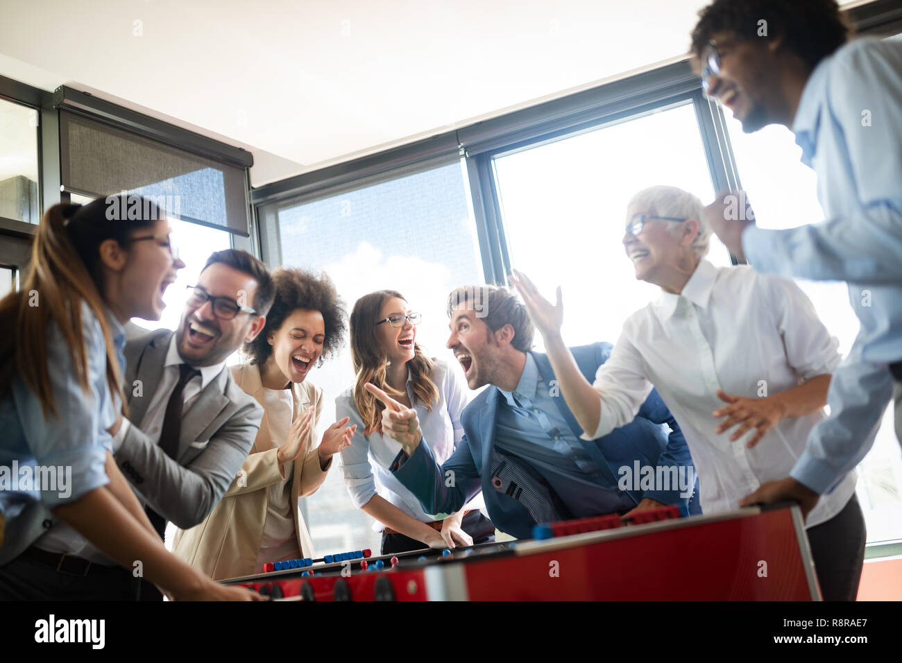 Multiracial people having fun in office room, excited diverse employees ...