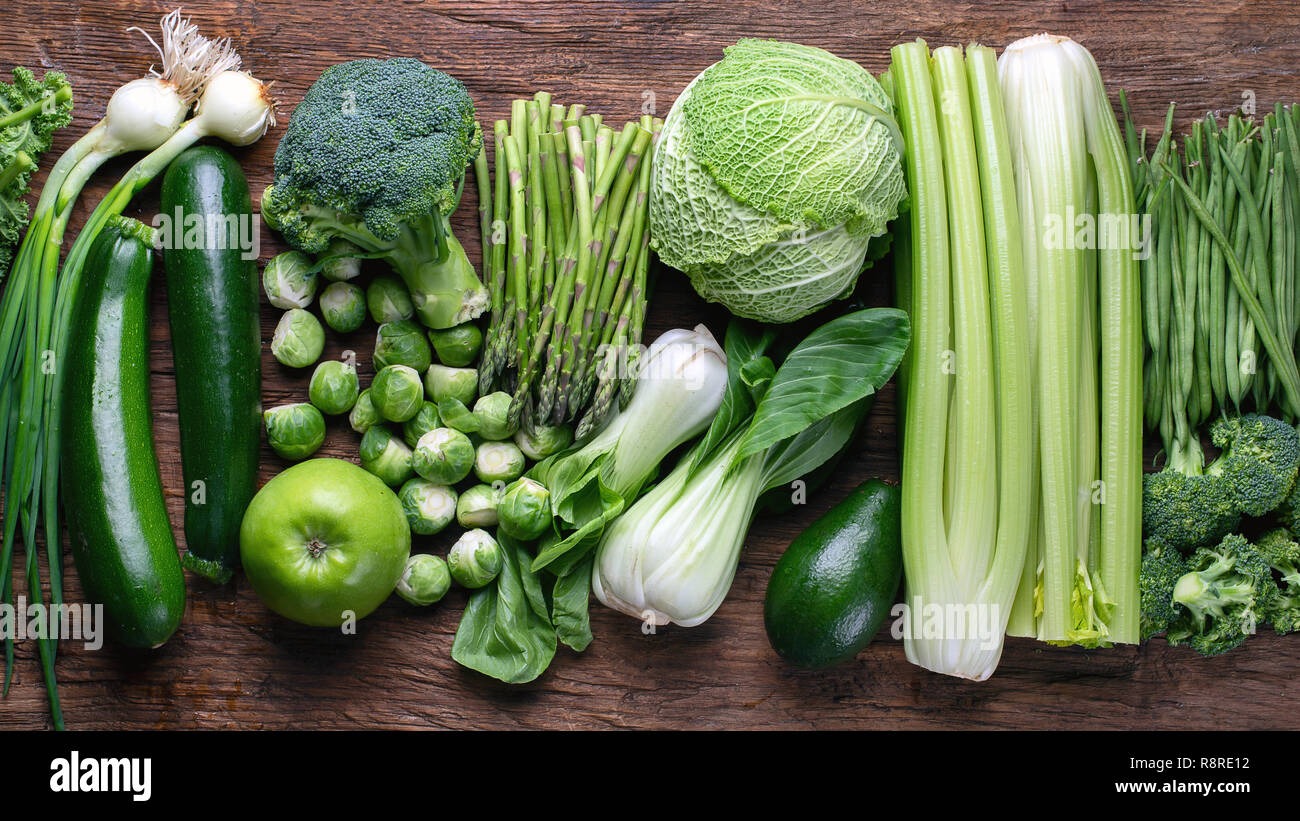 Fresh green vegetables on wooden table. Top view. Flat lay Stock Photo ...