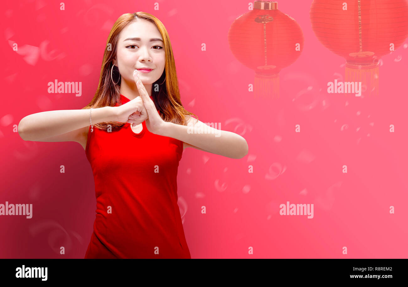 Smiling chinese woman showing congratulation gesture. Happy Chinese New ...