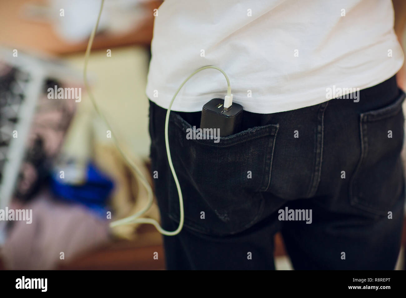man holding phone and charger. Powerbank and smartphone in hand. Power ...