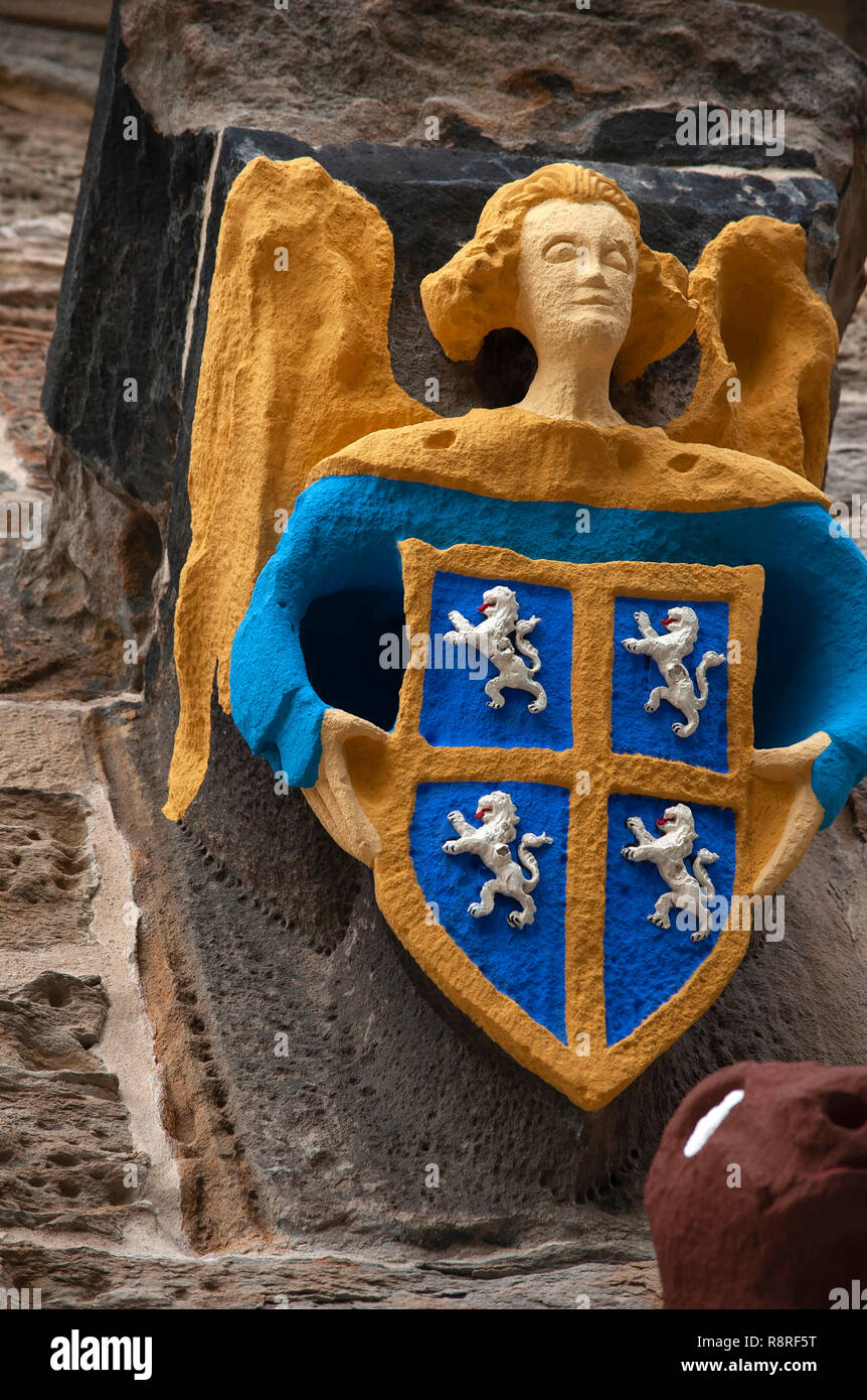 Carving of angel holding crest on palace green wall, Durham Stock Photo ...