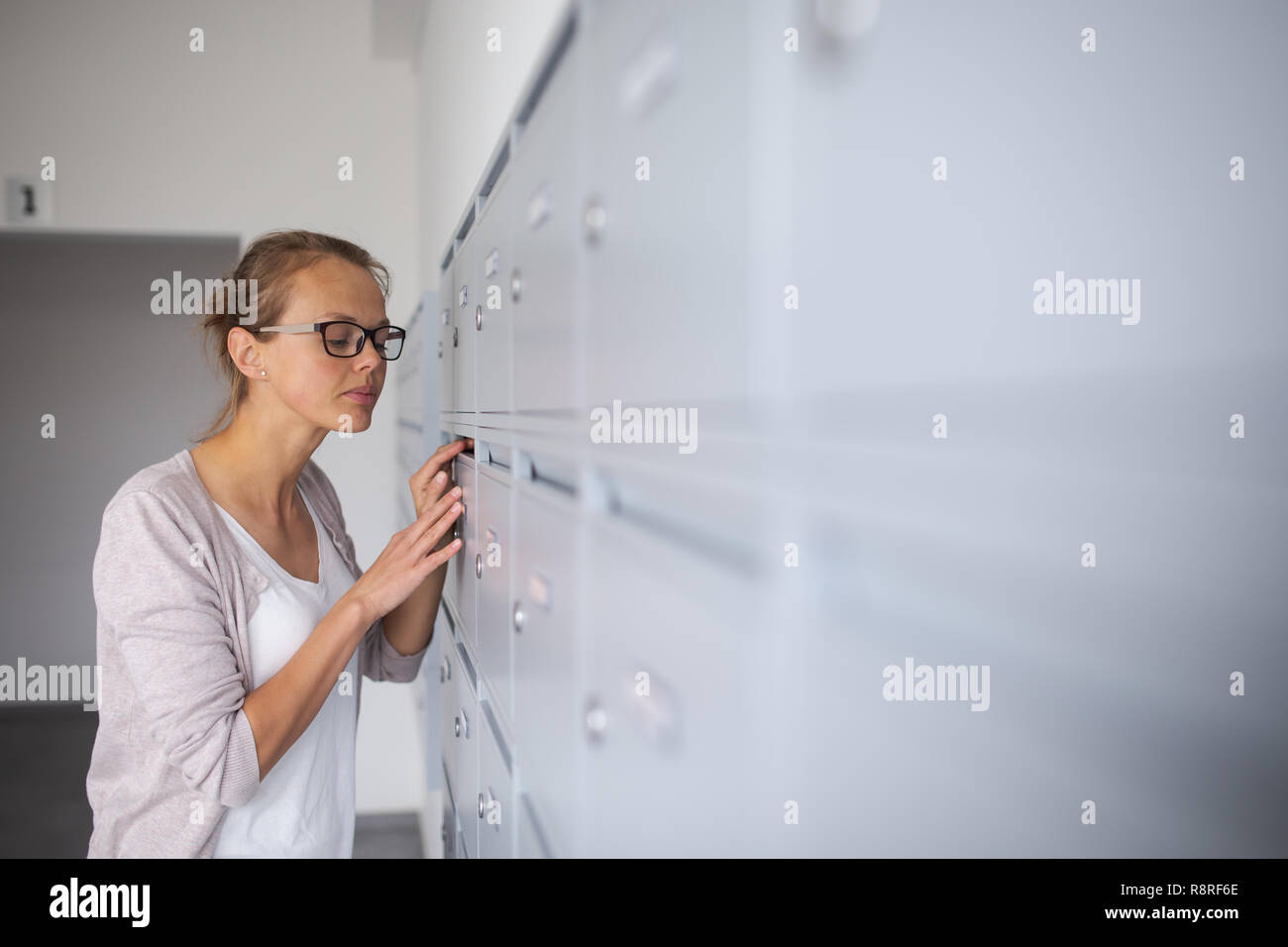 Pretty, young woman checking her mailbox for new letters Stock Photo ...