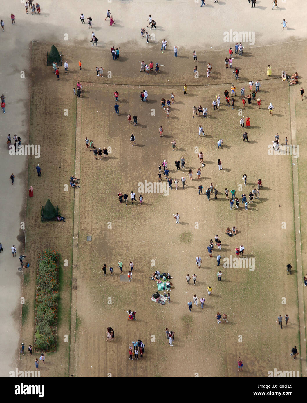 people who look very small seen from above in an outdoor public park ...