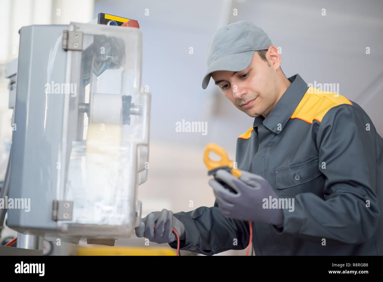 Mechanic fixing a machinery in an industrial environment Stock Photo ...