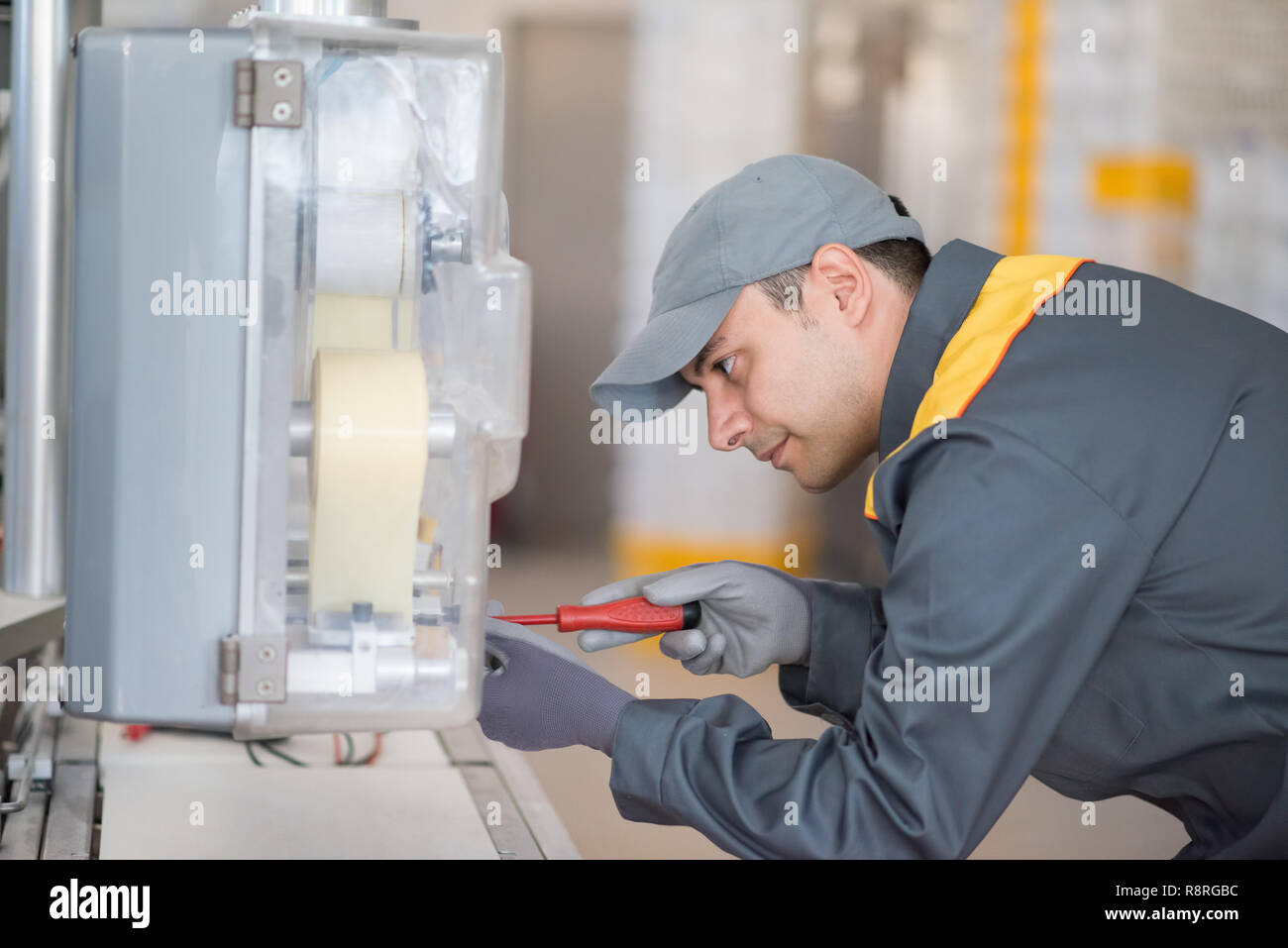 Mechanic fixing a machinery in an industrial environment Stock Photo ...