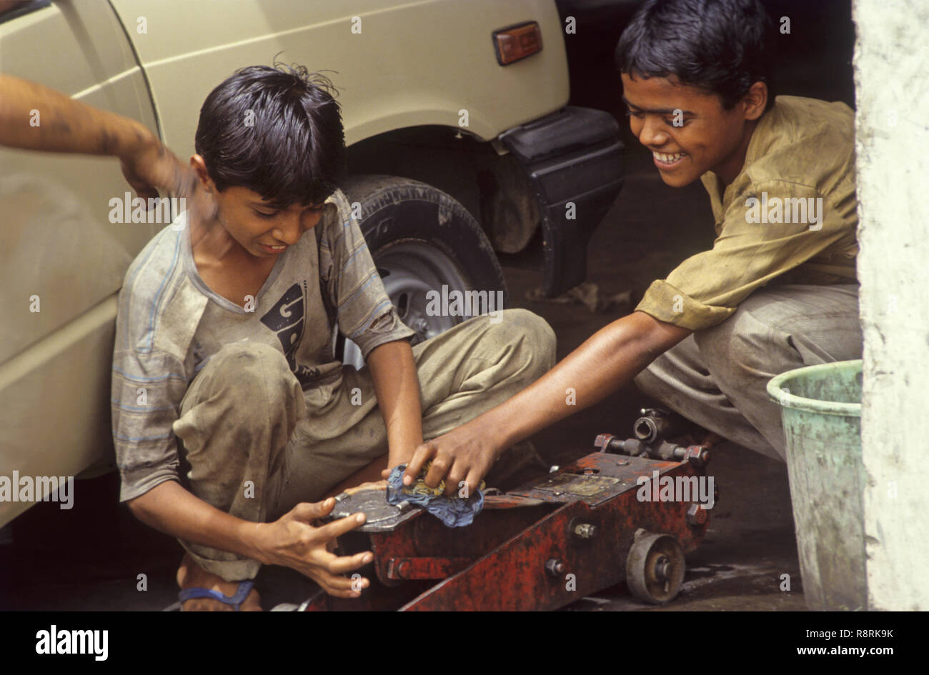 Two children working in auto garage, India, Asia Stock Photo - Alamy