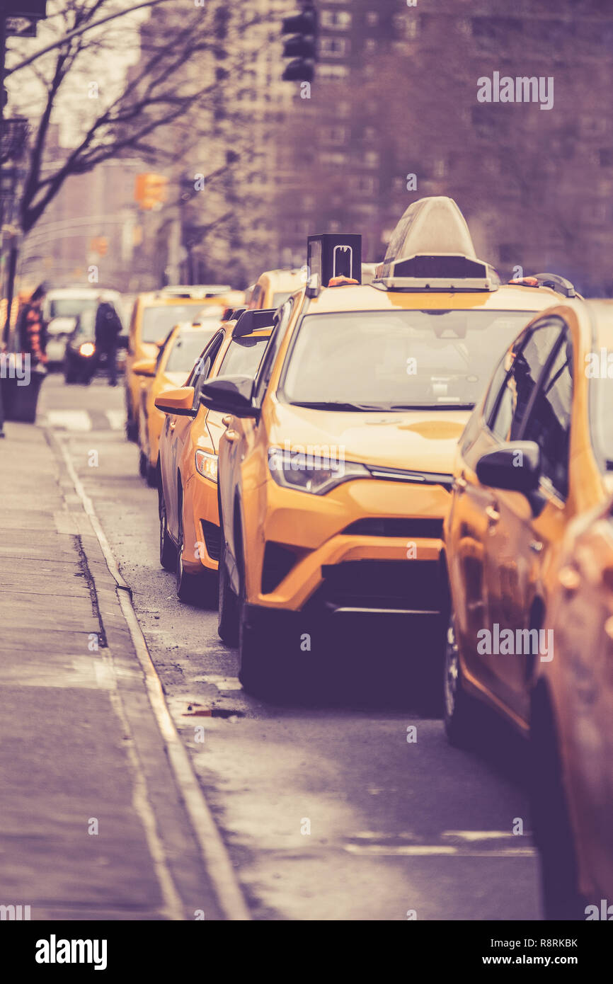 Vintage toned image of Line of New York City yellow taxicabs on street ...