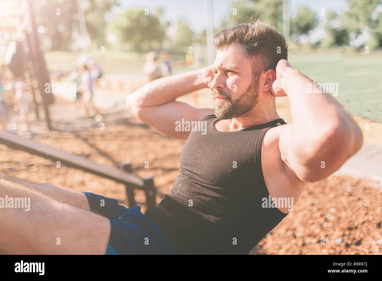 Muscular man exercising doing sit up exercise. Athlete with six pack ...