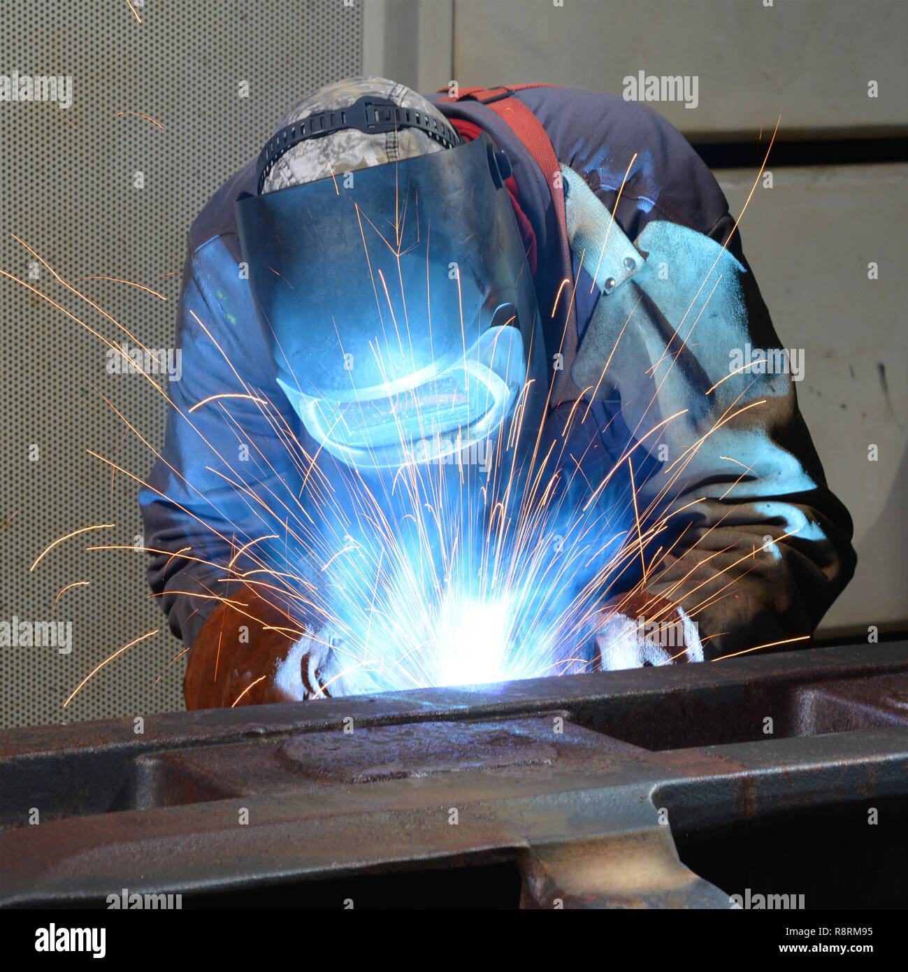 welder works in an industrial company - production of steel components ...