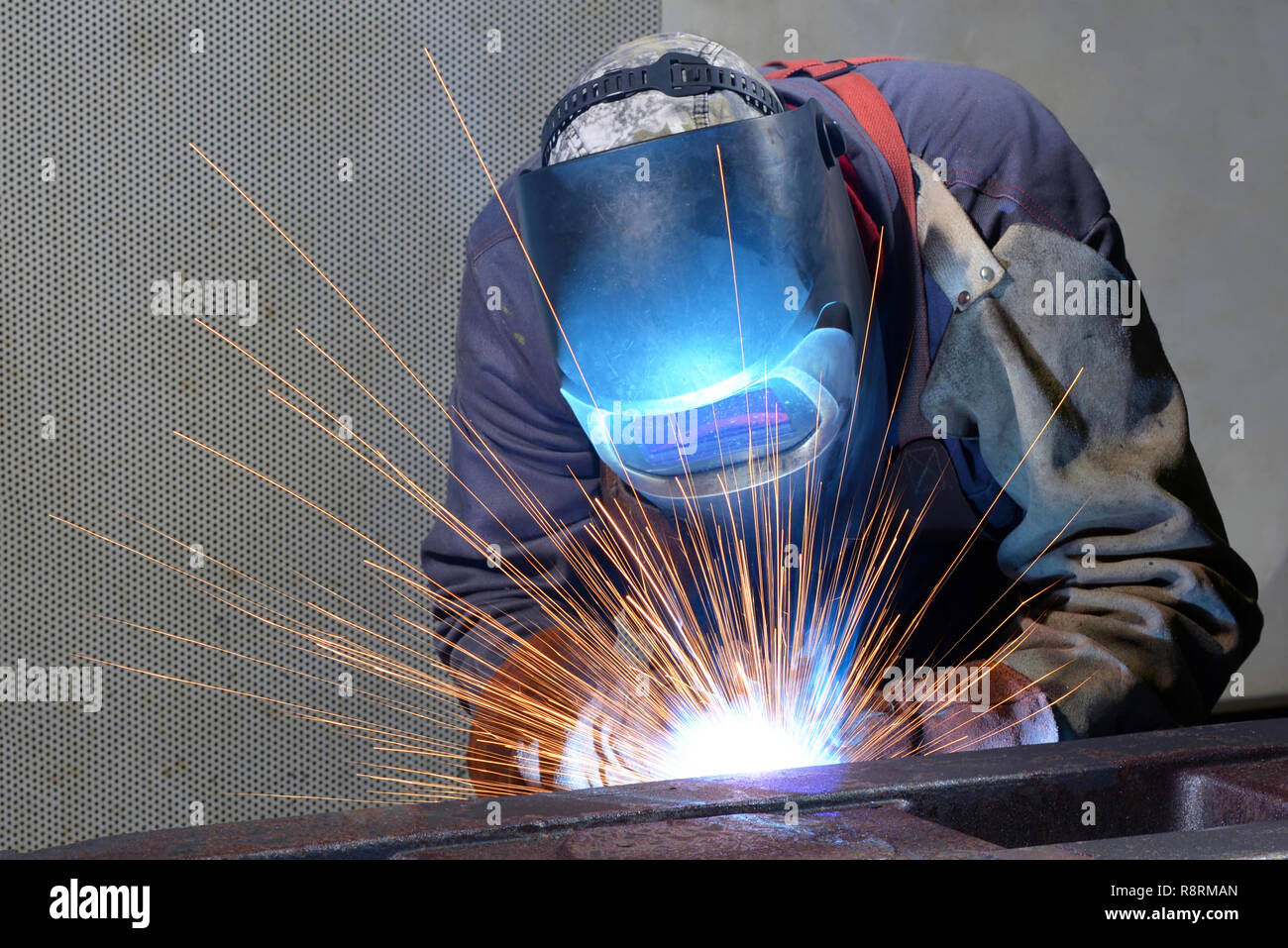 welder works in an industrial company - production of steel components ...