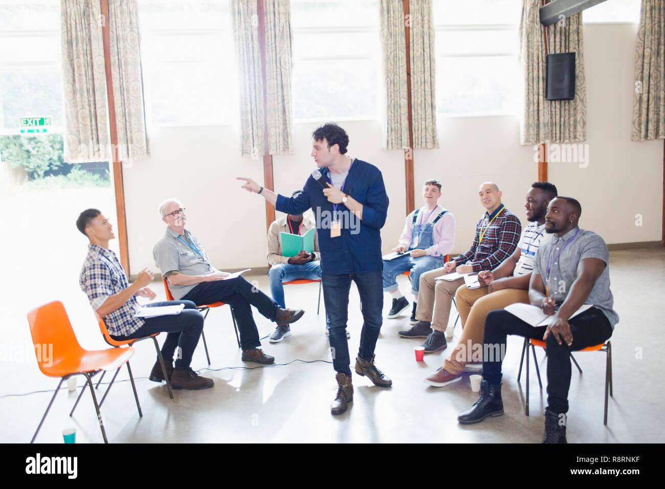 Man talking, leading group therapy Stock Photo - Alamy