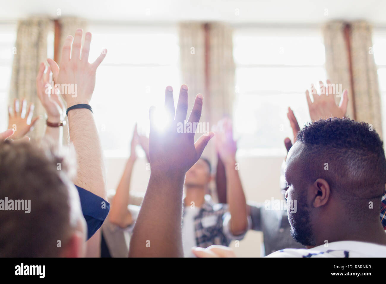 Men praying with arms raised in prayer group Stock Photo - Alamy
