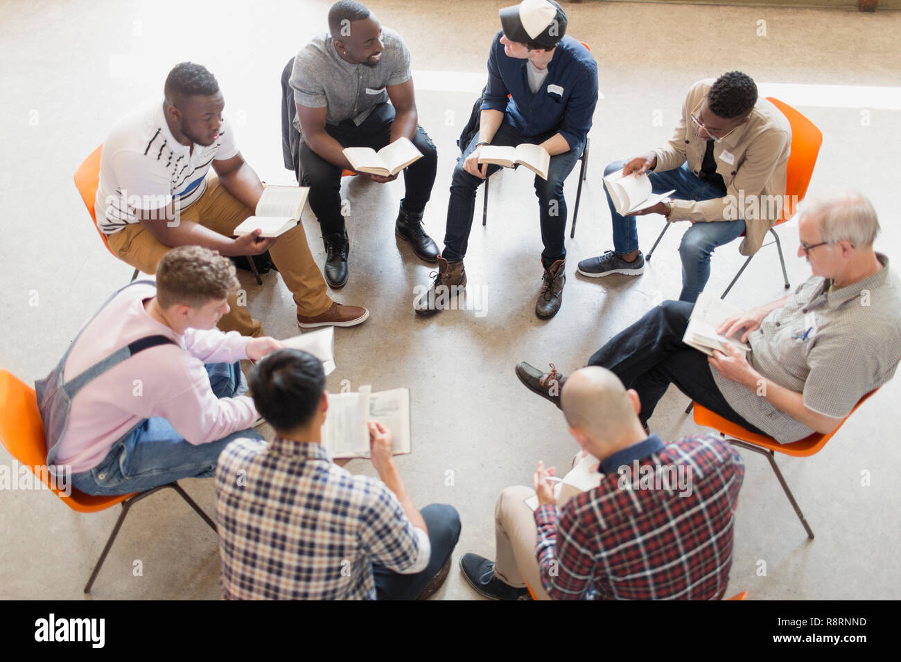 Men reading and discussing bible in prayer group circle Stock Photo - Alamy