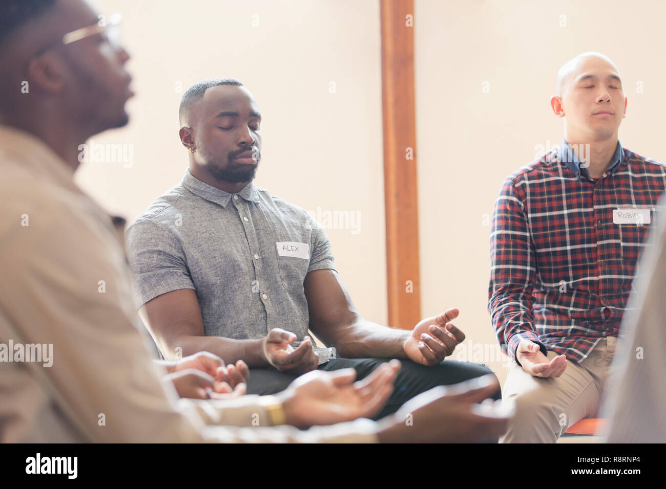 Men praying with eyes closed in prayer group Stock Photo - Alamy