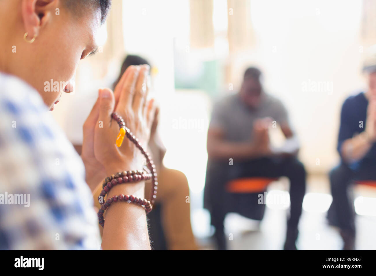 Man praying with prayer beads in prayer group Stock Photo - Alamy