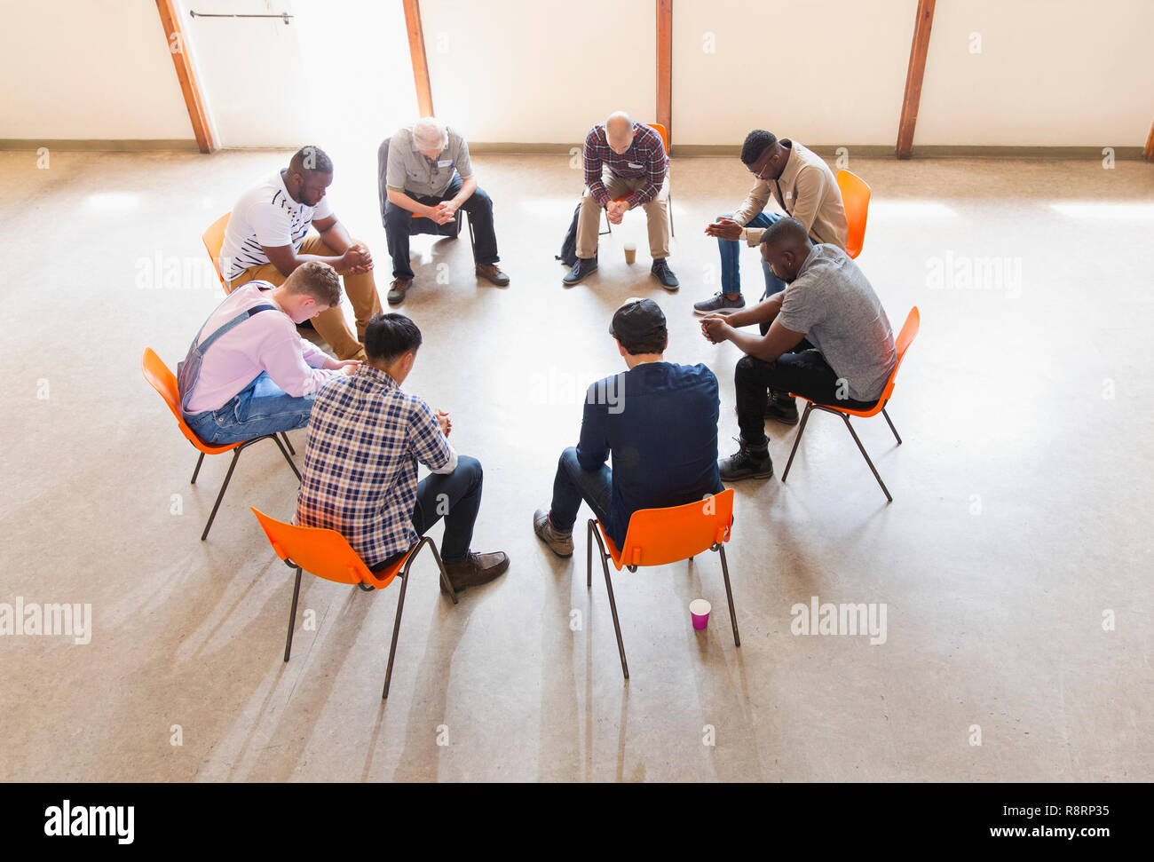 Men praying in circle in prayer group Stock Photo - Alamy