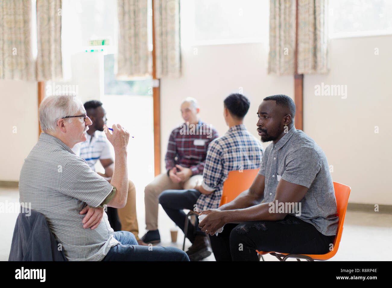 Group talking serious hi-res stock photography and images - Alamy