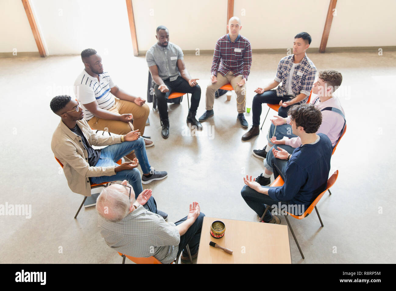 Men praying in circle in prayer group Stock Photo - Alamy