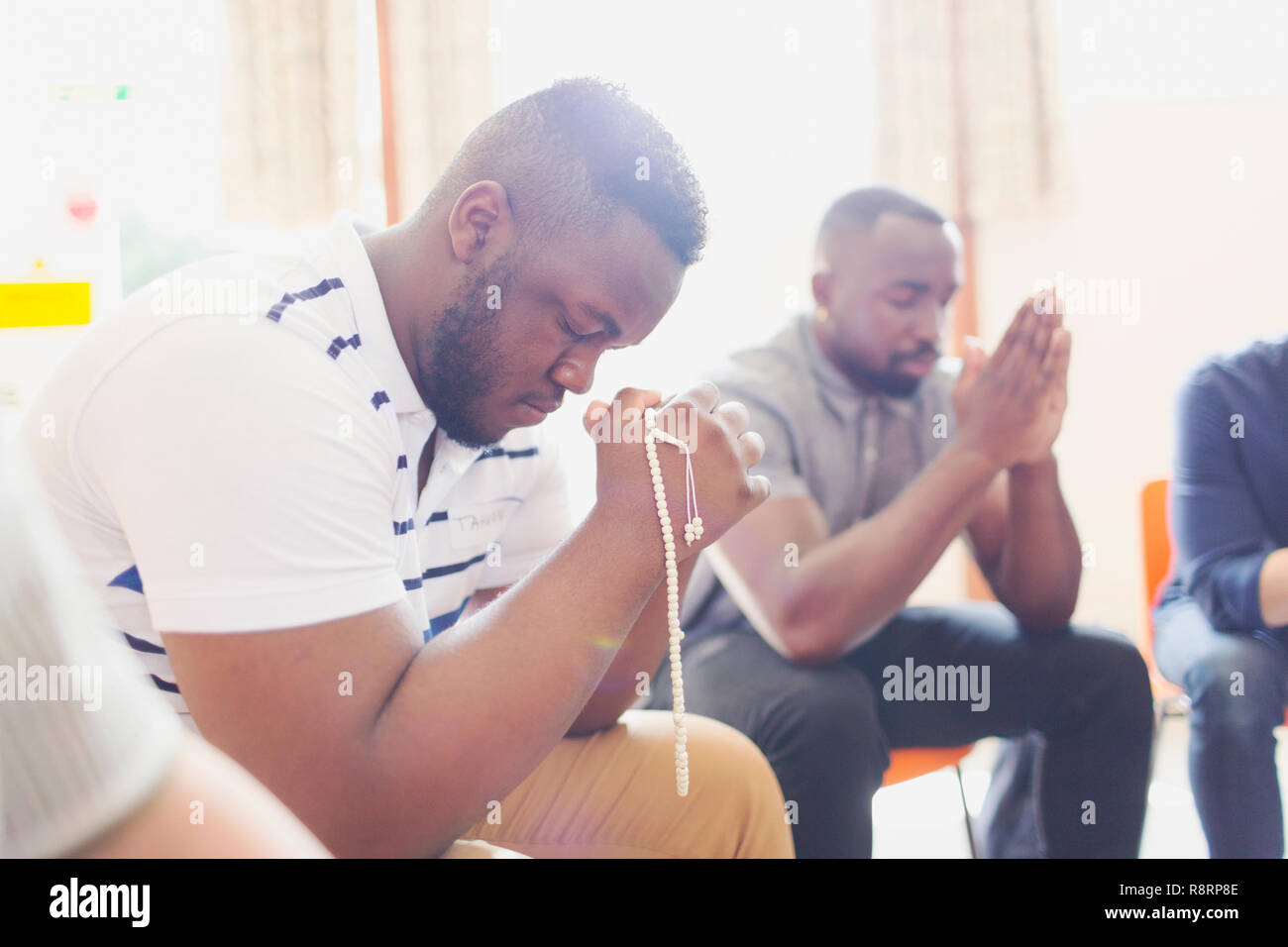 Man praying with prayer beads in prayer group Stock Photo - Alamy