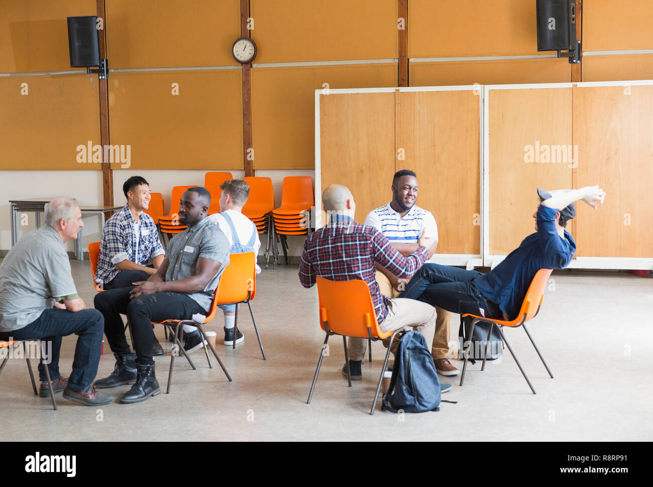 Men talking in group therapy in community center Stock Photo - Alamy