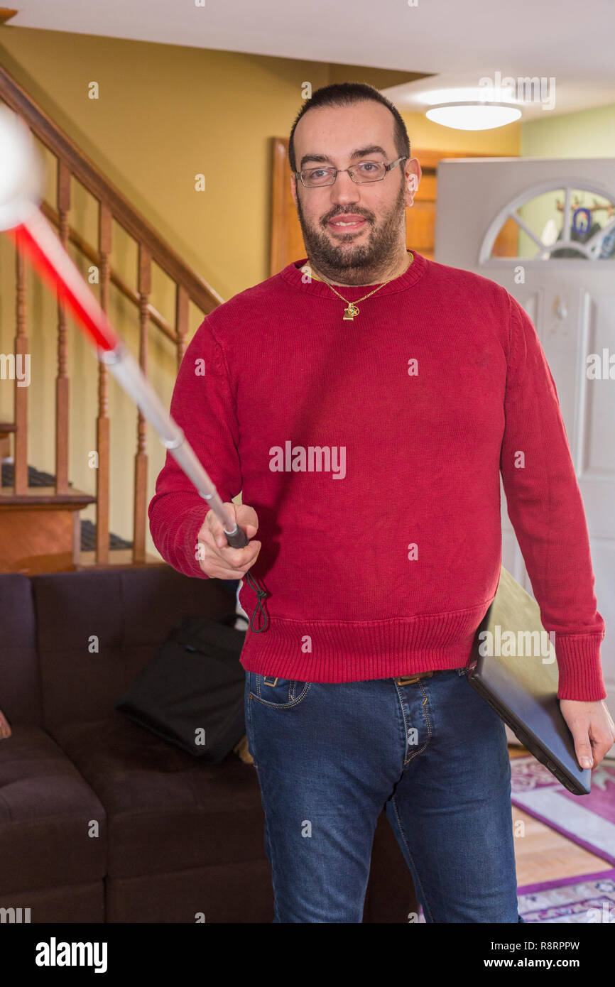 Man who has Visual Impairment with his cane at home Stock Photo - Alamy