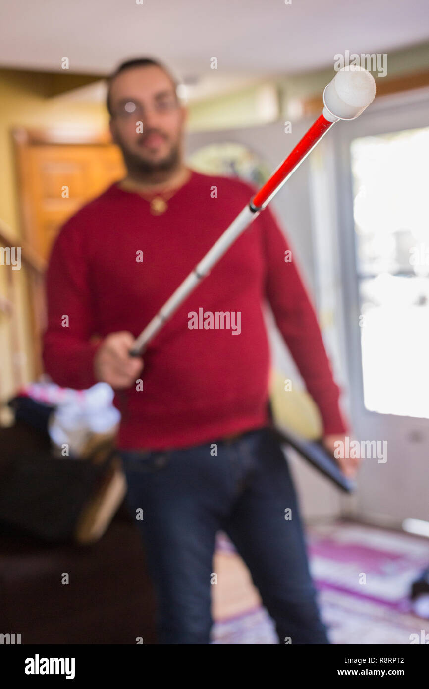 Man who has Visual Impairment with his cane at home Stock Photo - Alamy