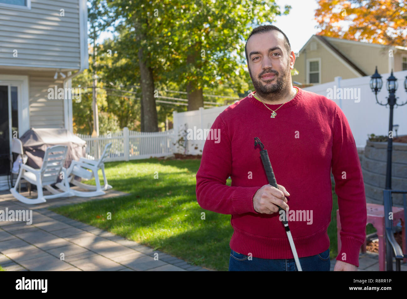 Man with Visual Impairment using his cane outdoors Stock Photo - Alamy