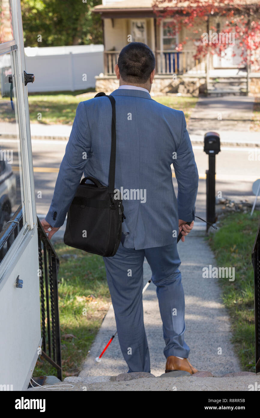 Businessman with Visual Impairment going outside with his cane Stock ...