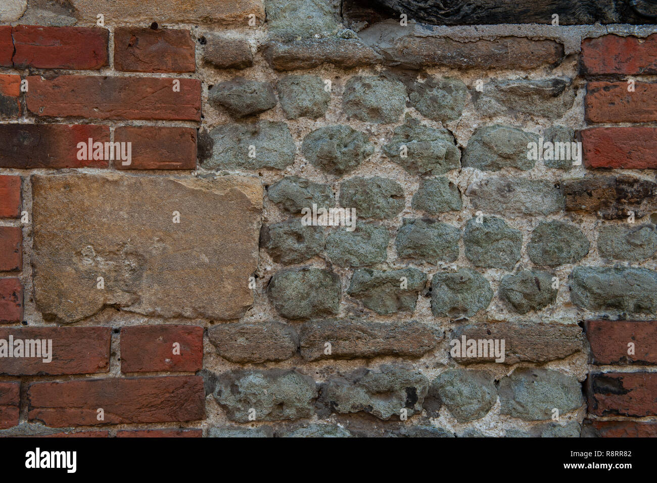 Wall built from mixed material Stock Photo - Alamy