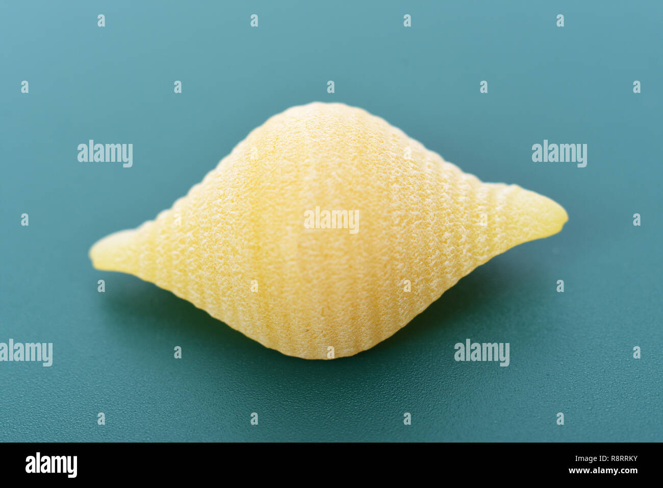 Pasta conchiglie on green background Stock Photo - Alamy