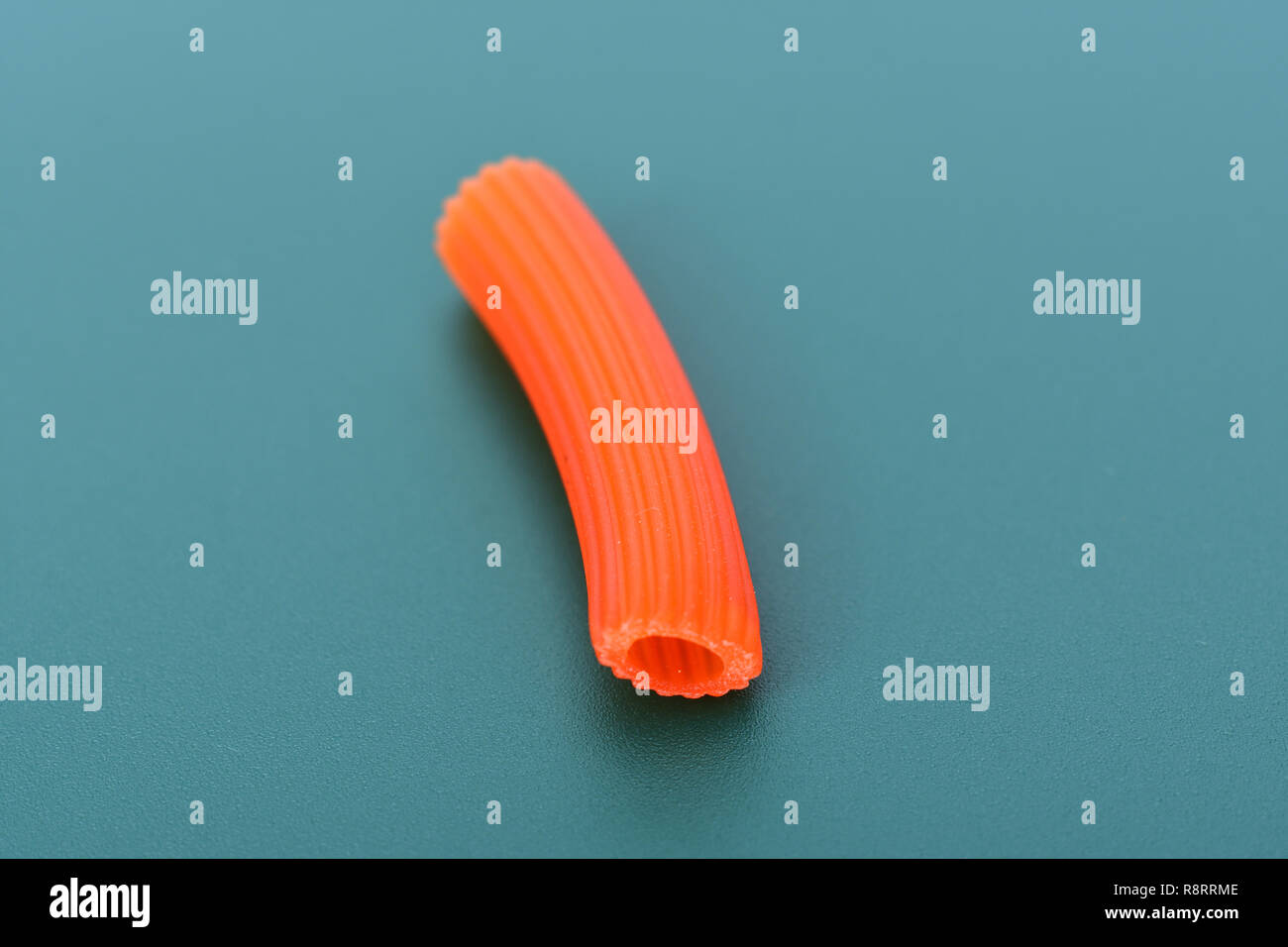 Pasta red macaroni on green Stock Photo - Alamy