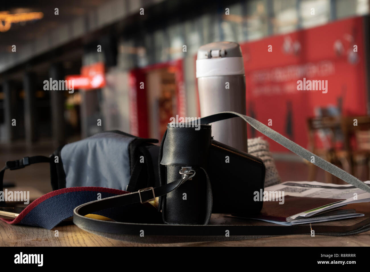 Thermos and two cameras on the table on the airport Stock Photo - Alamy