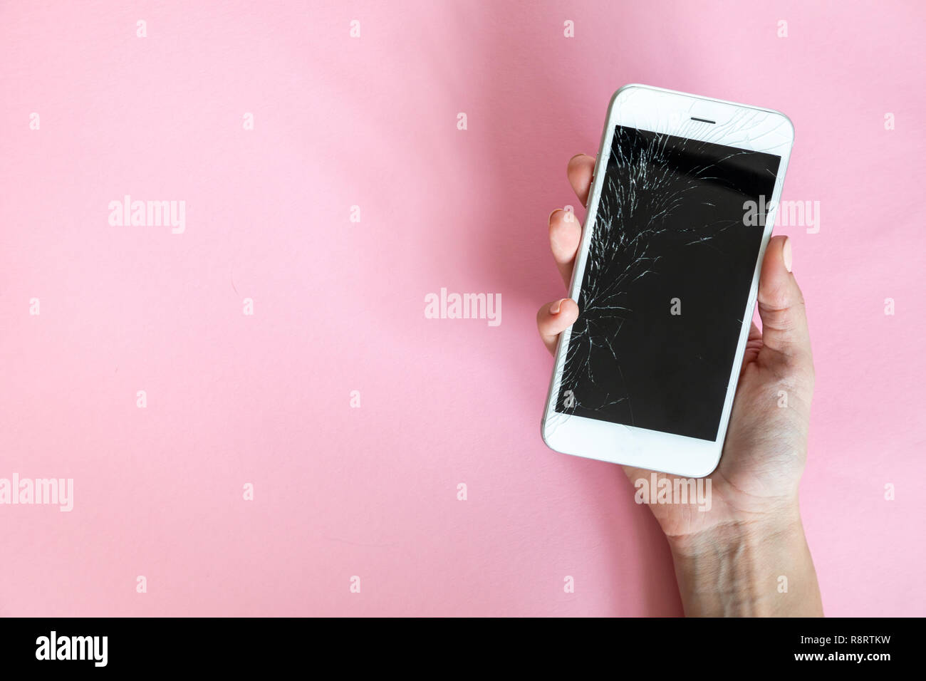 Smartphone with broken screen in hand on pink background Stock Photo ...