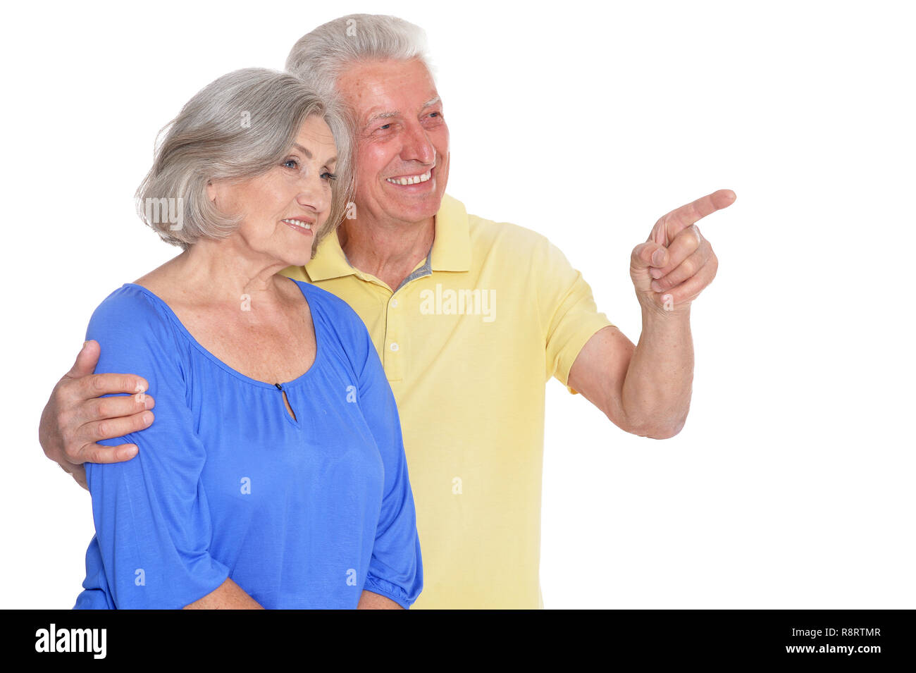 Senior couple pointing isolated on white background Stock Photo - Alamy