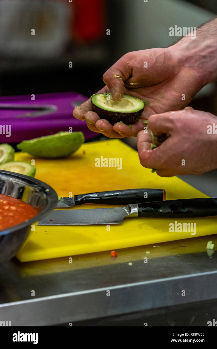 Male Chef Pealing Avocado for Wedding Meal - Kitchen Set with Isolated ...