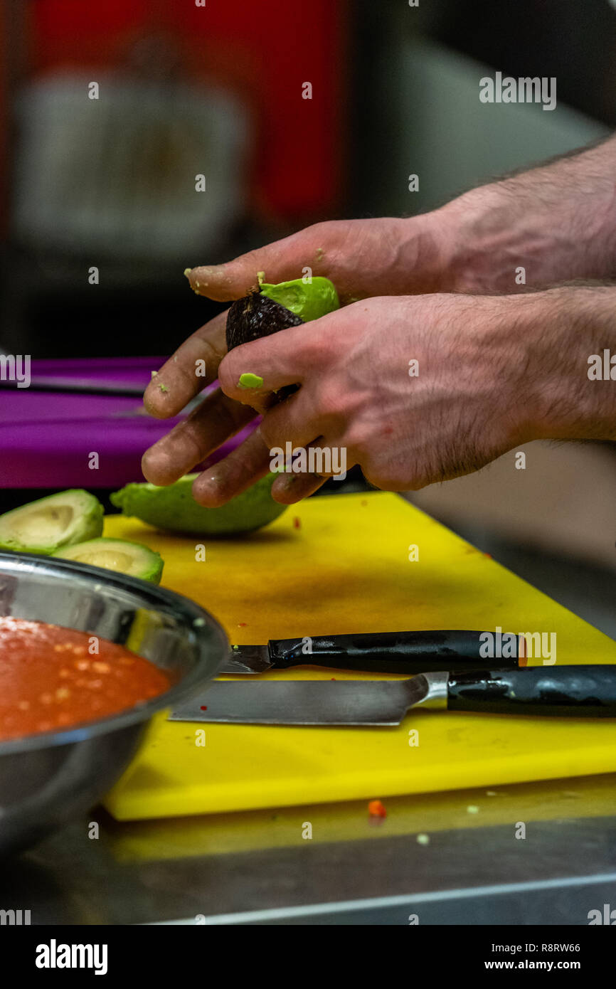 Male Chef Pealing Avocado for Wedding Meal - Kitchen Set with Isolated ...